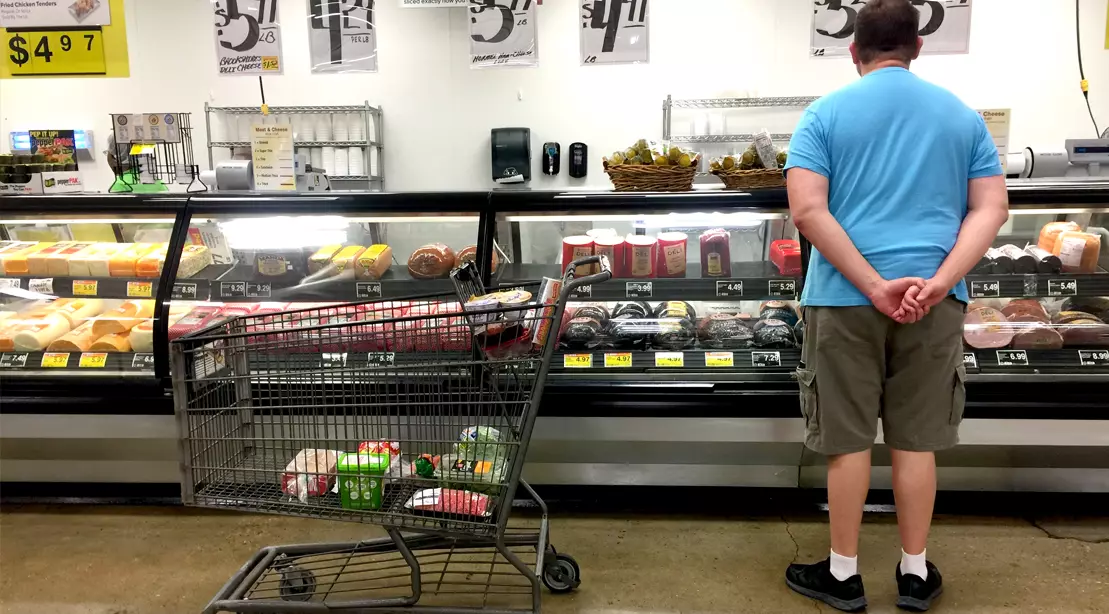 Man-Waiting-at-The-Deli-In-Grocery-Margadh