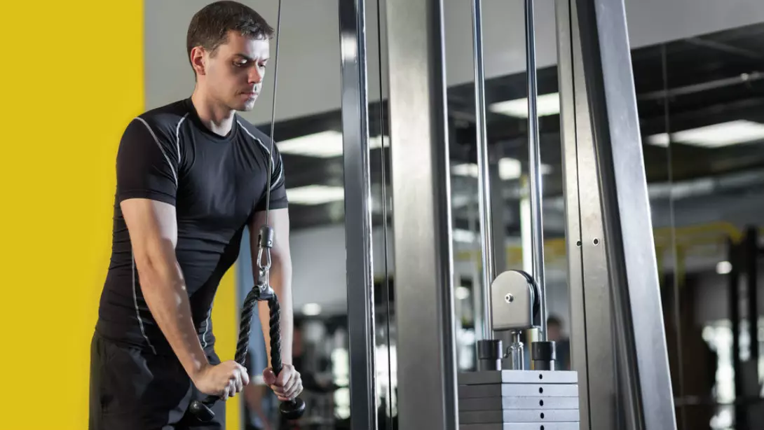 Yellow gym wall tricep pushdown