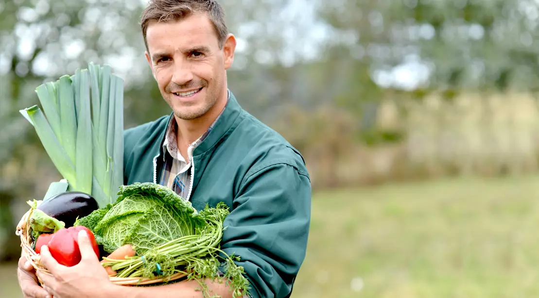 Man-Holding-A-Basket-Full-Of-Vegetables