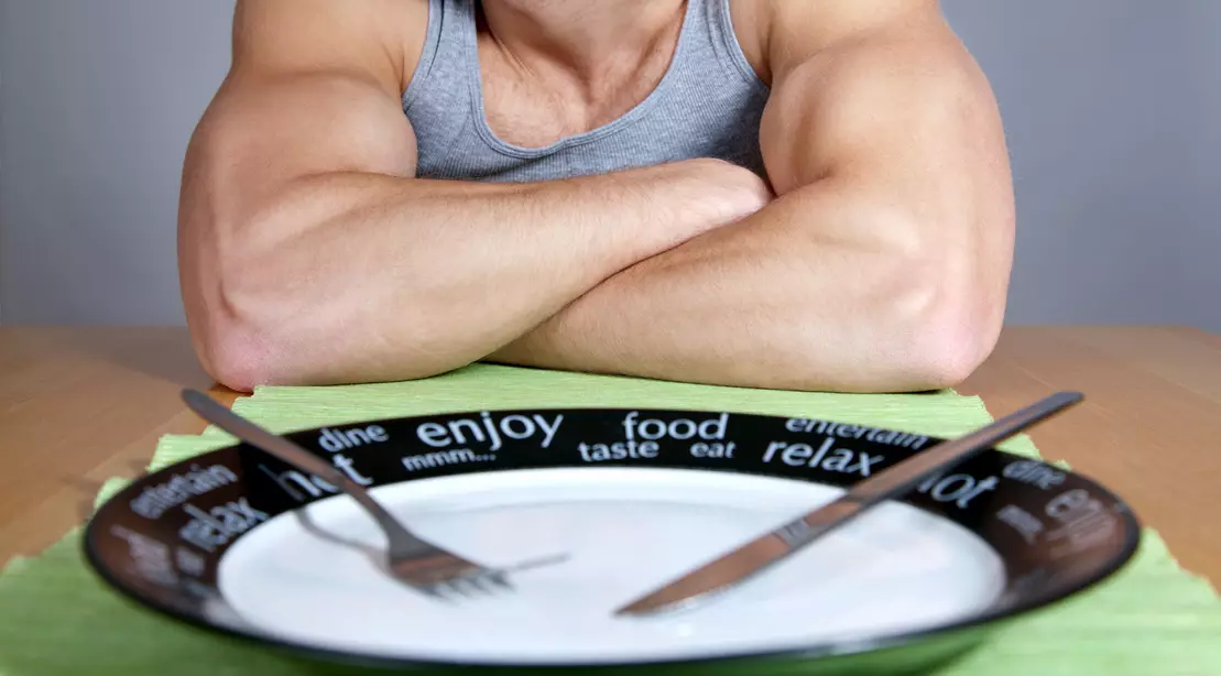 Muscular-Man-Naglingkod-In-Front-of-Empty-Plate